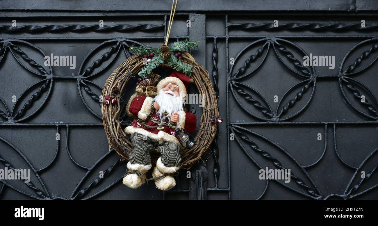 Traditional handcrafted iron entrance gate with a festive Santa Claus ...