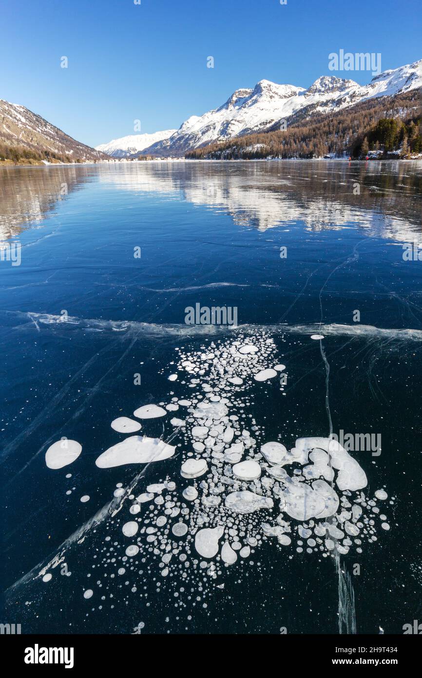 Trapped methane bubbles under the frozen lake with landscape as ...