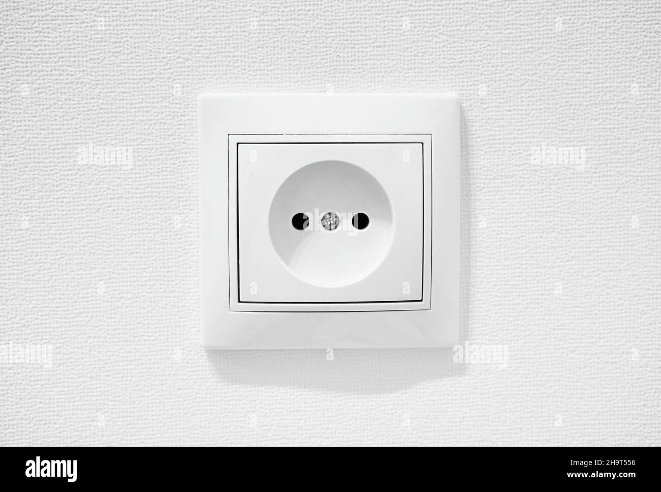 Common cheap plastic AC power wall socket. German circular recess ...