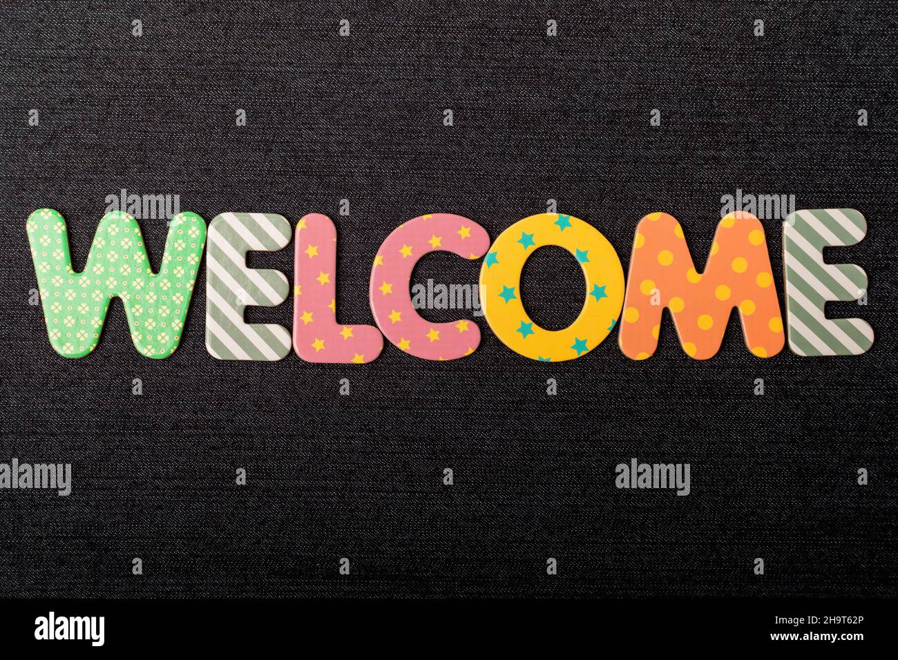 Card with Welcome word made from mixed vivid colored wooden letters on ...
