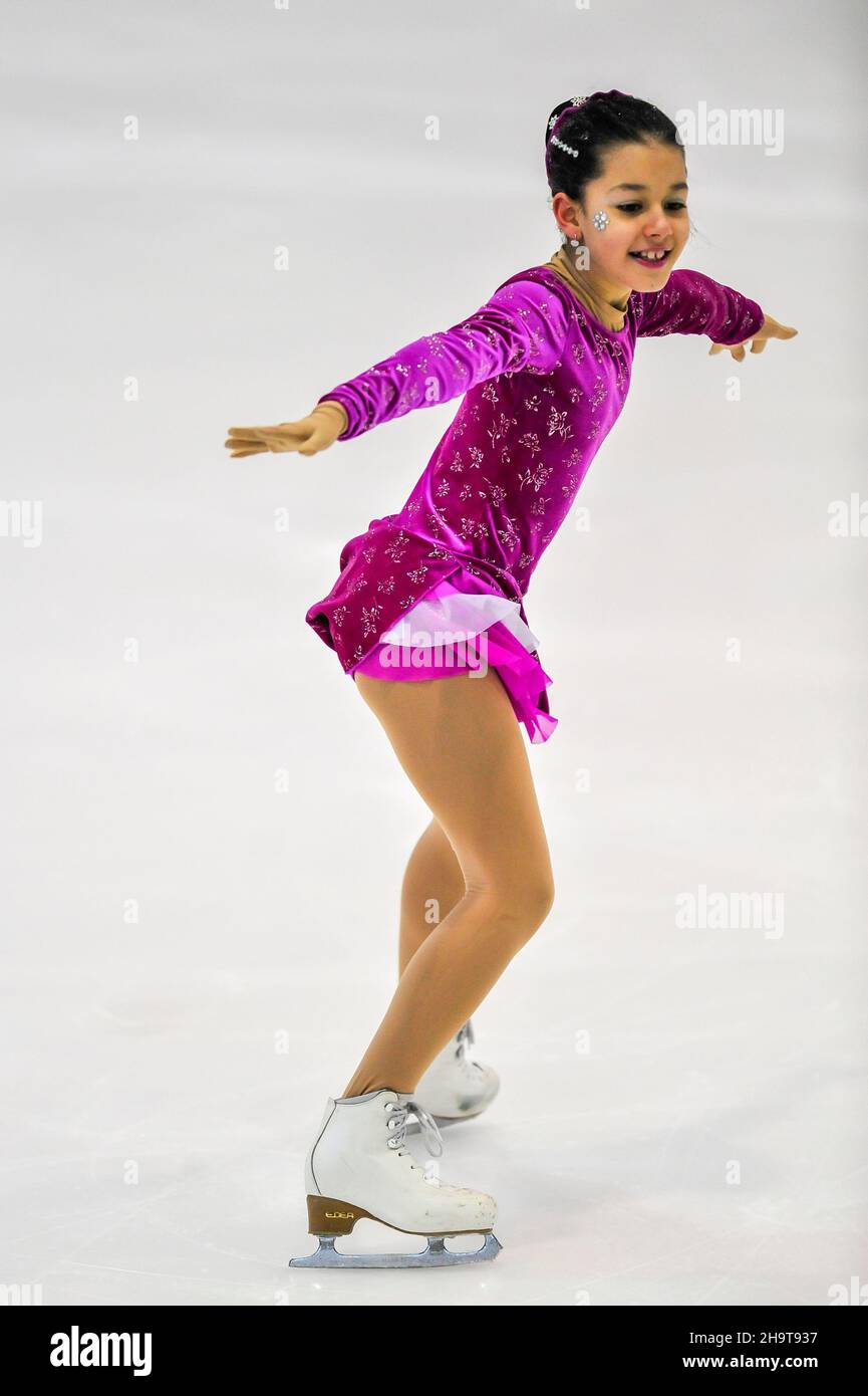 Little girl figure skater skating on ice indoor Stock Photo - Alamy