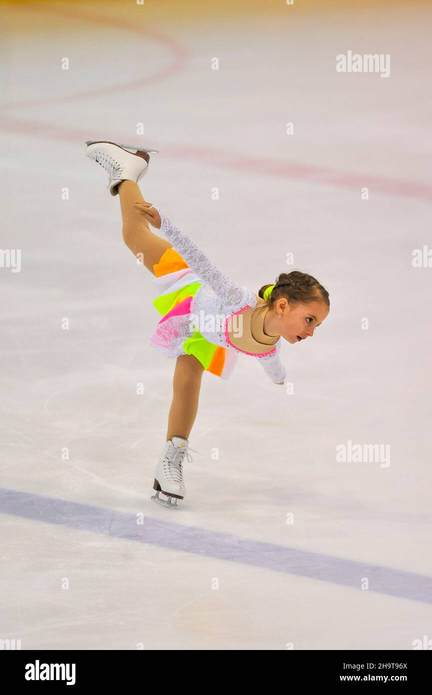 Little girl figure skater skating on ice indoor Stock Photo - Alamy