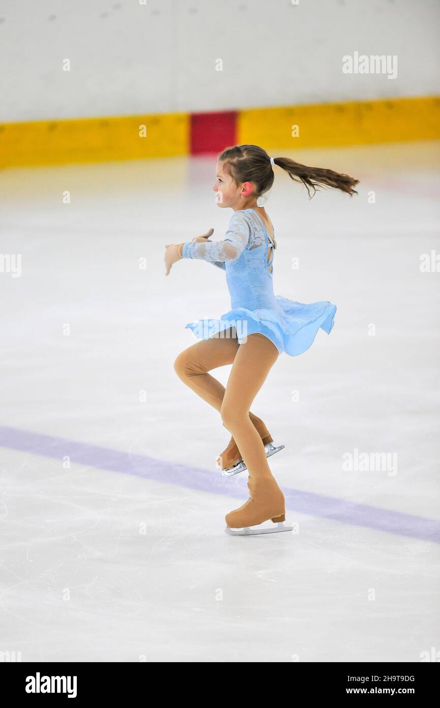 Little girl figure skater skating on ice indoor Stock Photo - Alamy
