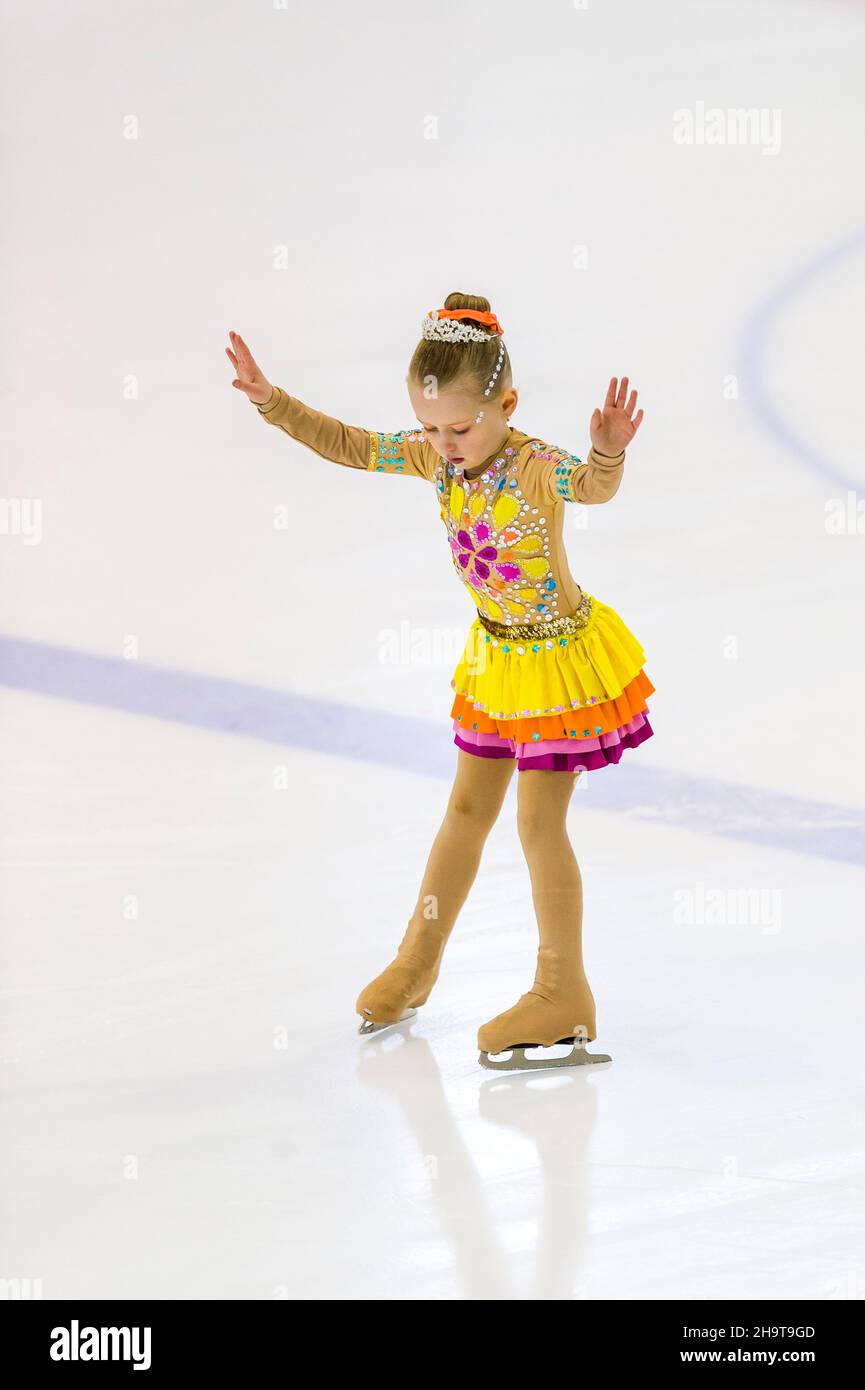 Little girl figure skater skating on ice indoor Stock Photo - Alamy