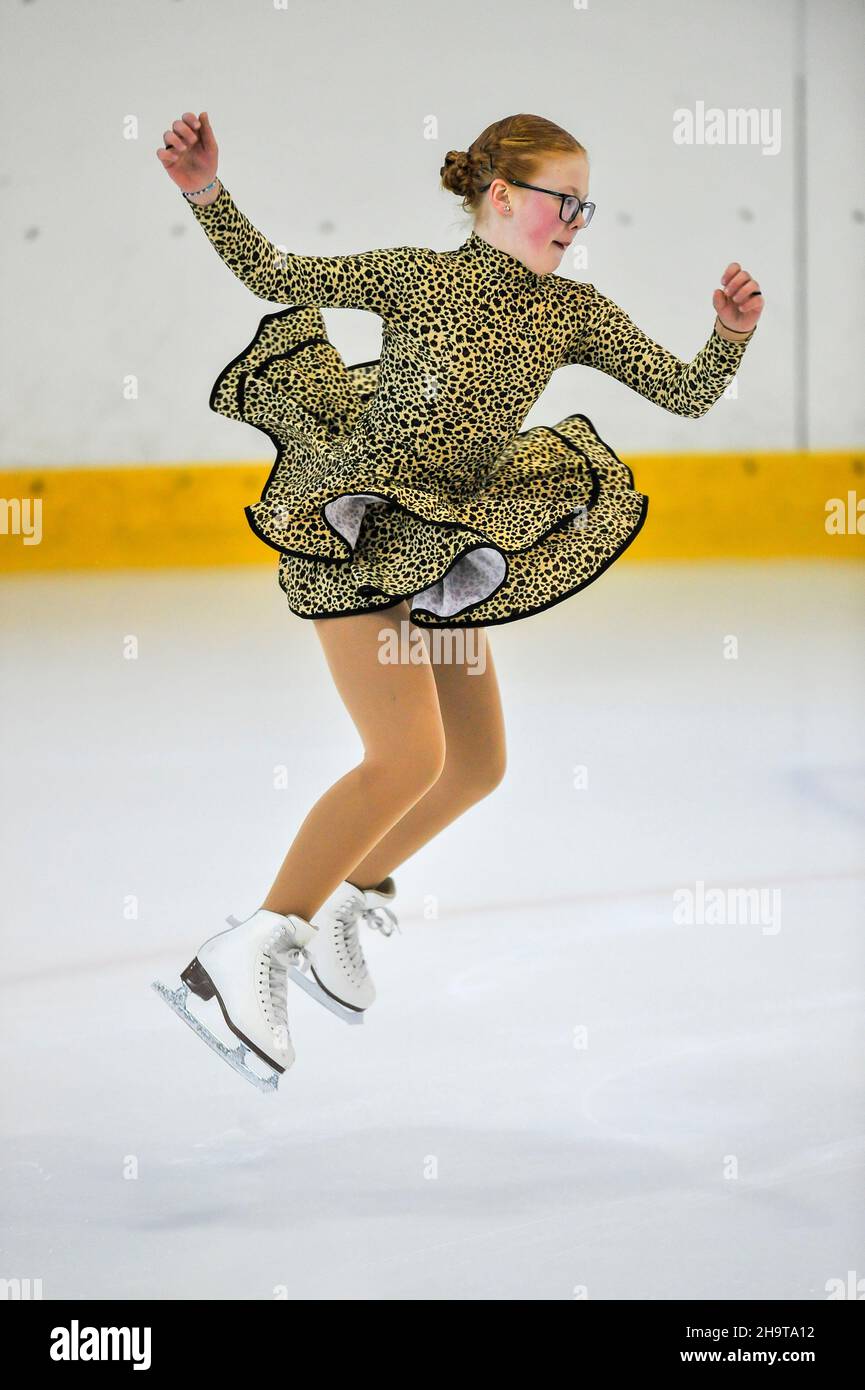 Little girl figure skater skating on ice indoor Stock Photo - Alamy