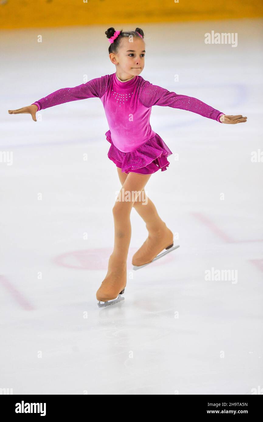 Little girl figure skater skating on ice indoor Stock Photo - Alamy