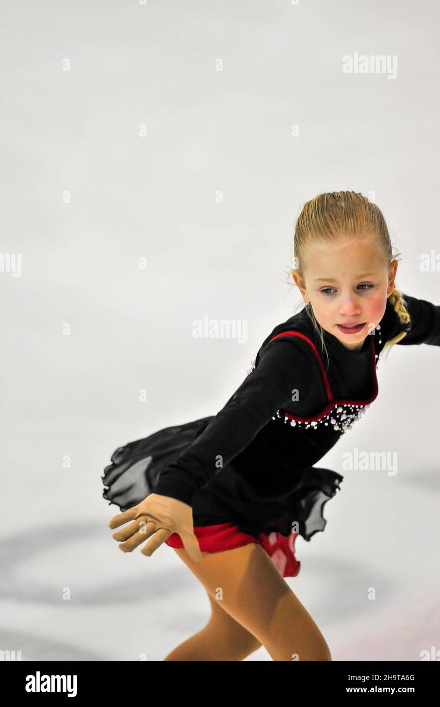 Little girl figure skater skating on ice indoor Stock Photo - Alamy