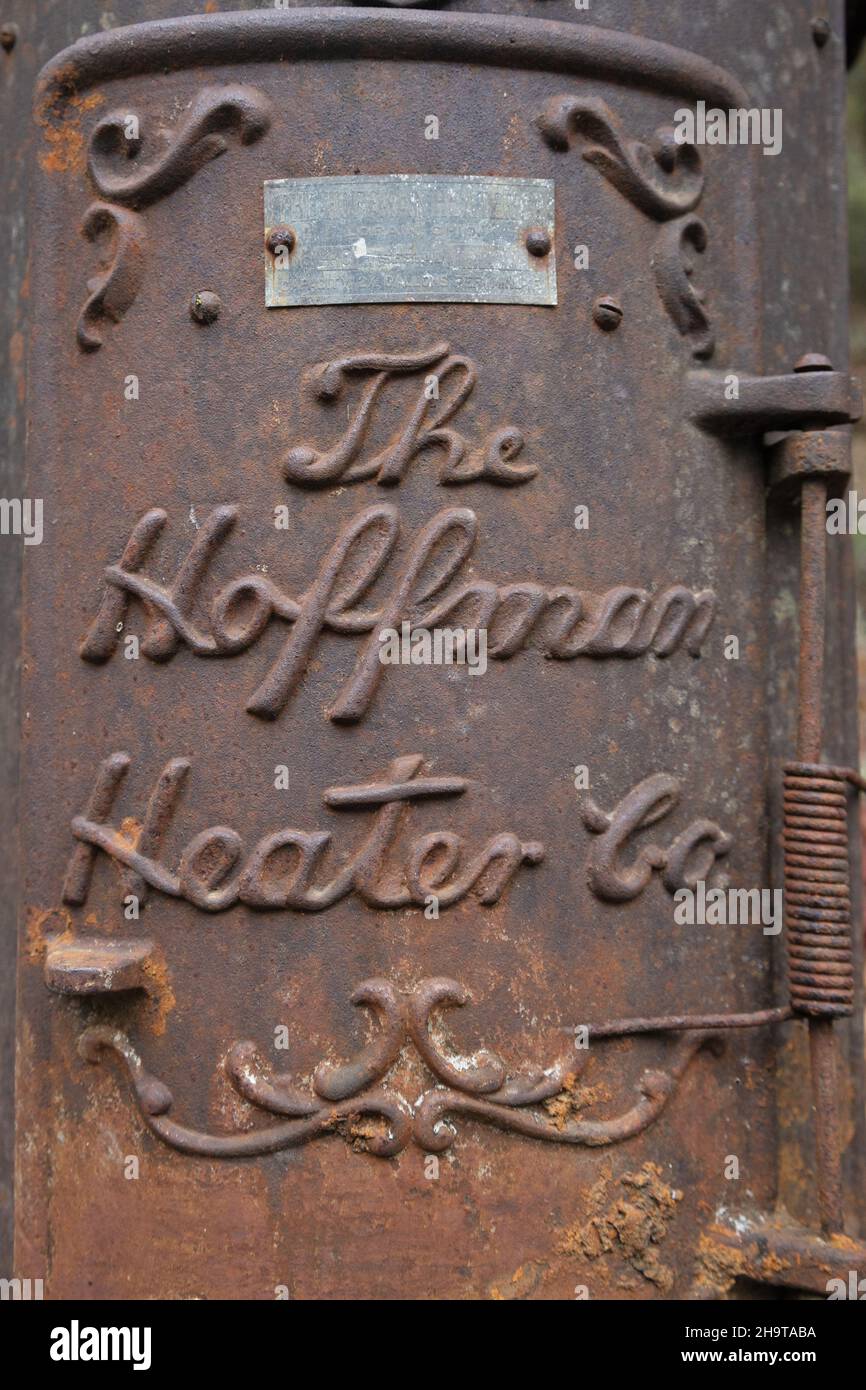 The rusty door of an old heater, with words "Hoffman Heater Co ...