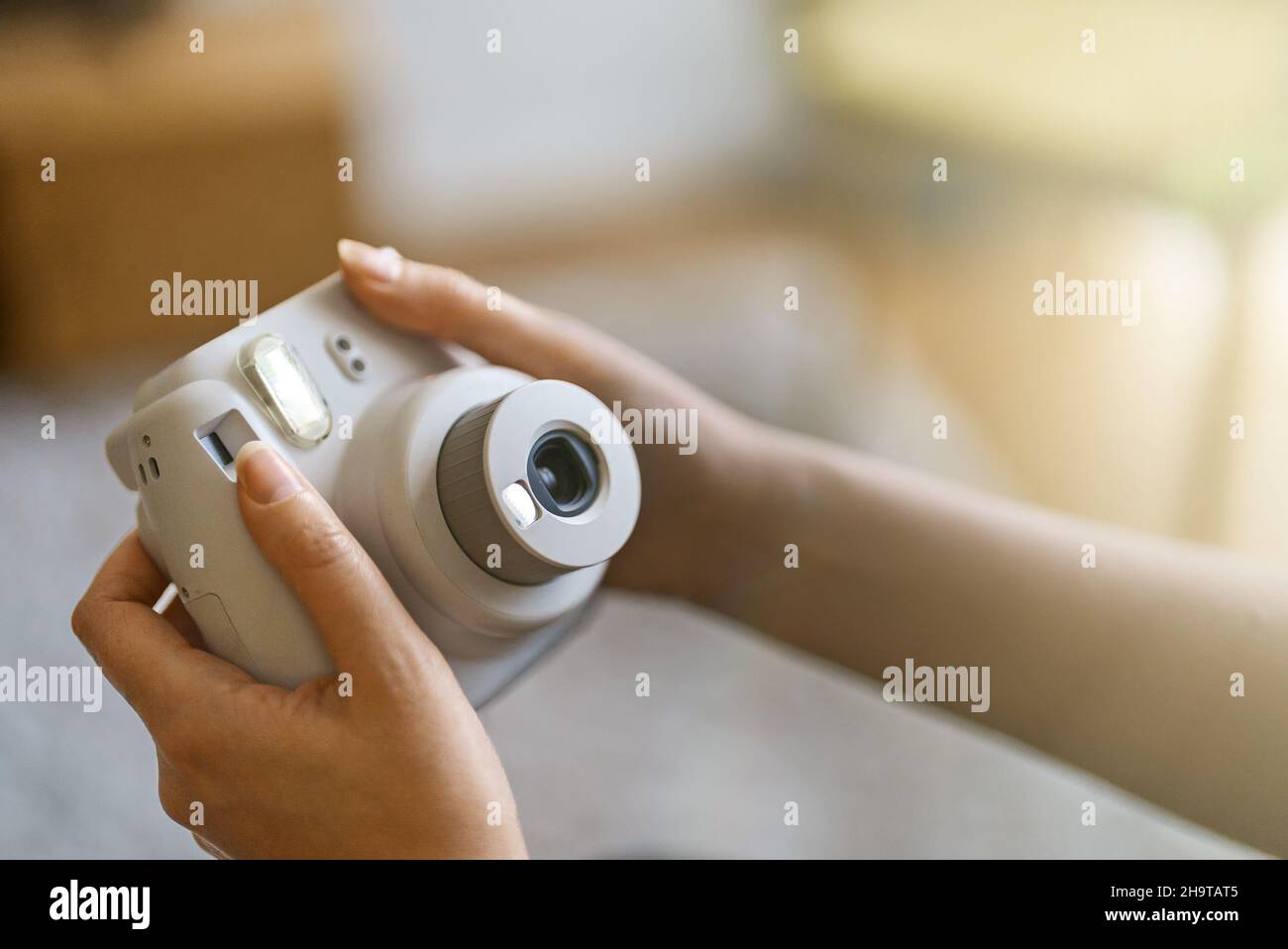 Woman doing selfie photo with instant camera Stock Photo - Alamy