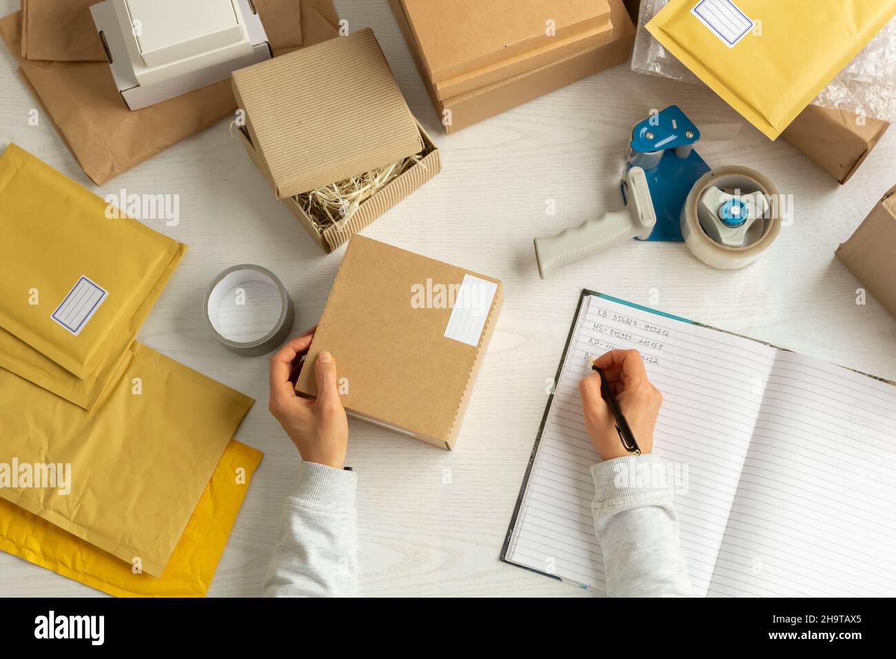 Warehouse worker at the workplace distributes deliveries in boxes and ...