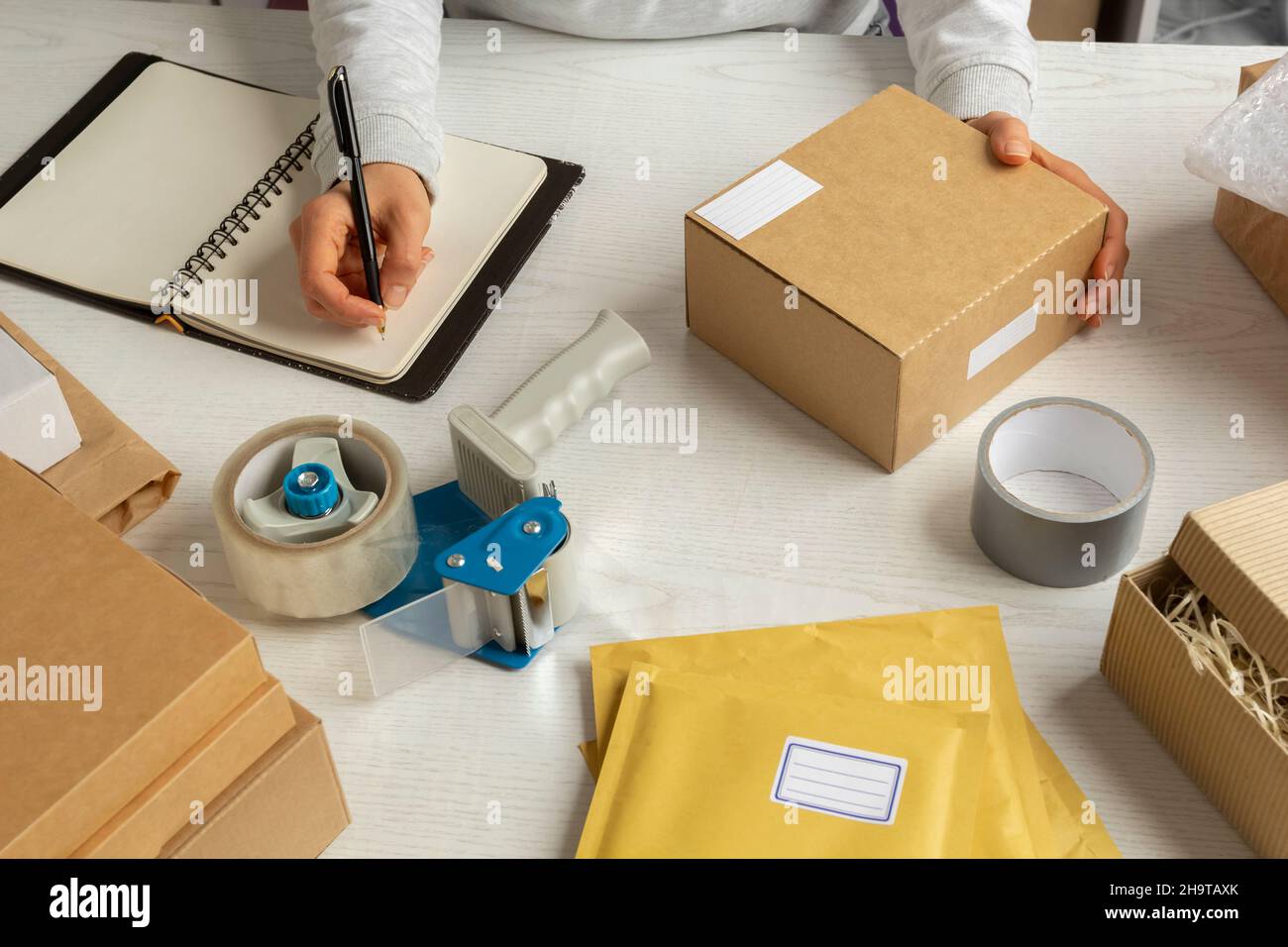 Warehouse worker at the workplace distributes deliveries in boxes and ...