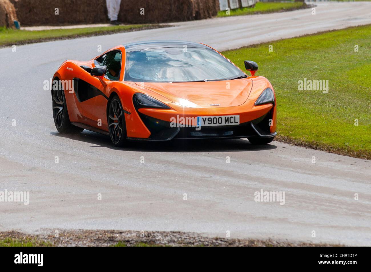 McLaren 570S Sprint driving up the hill climb at the Goodwood Festival ...