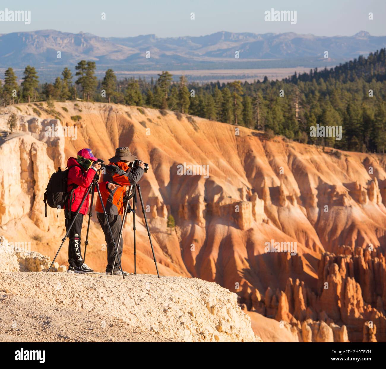 Bryce Canyon National Park, Utah, USA. Two photographers at cliff edge ...