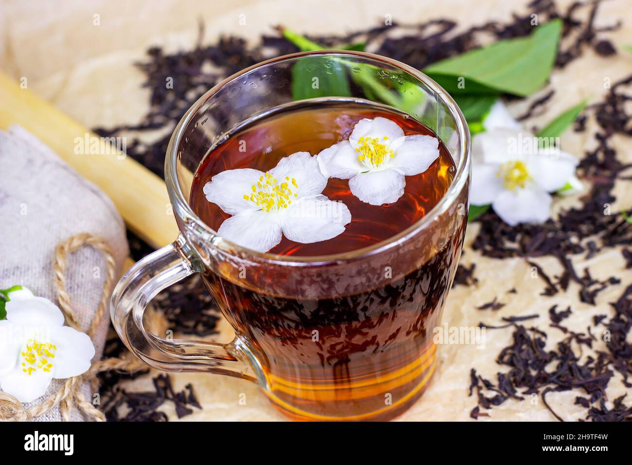 Fresh organic aromatic herbal tea in the glass cup with white jasmine ...