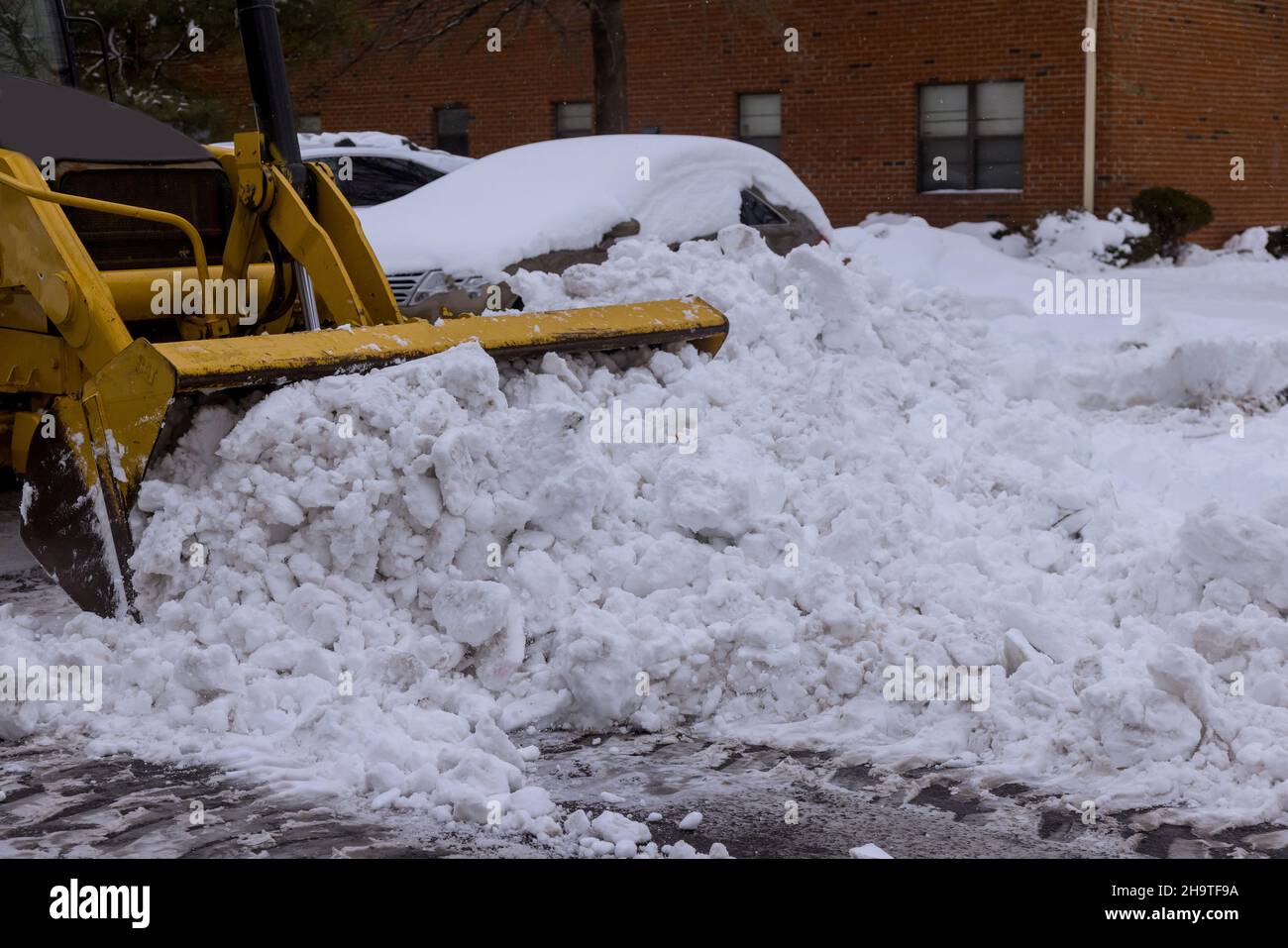 Tractor clears snow clearing roadway after heavy snowfall Stock Photo ...