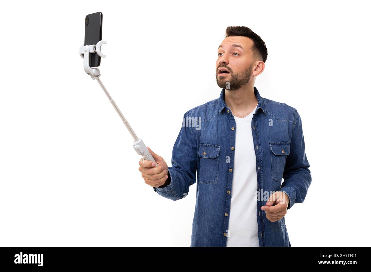 a man records a video with a selfie stick Stock Photo - Alamy