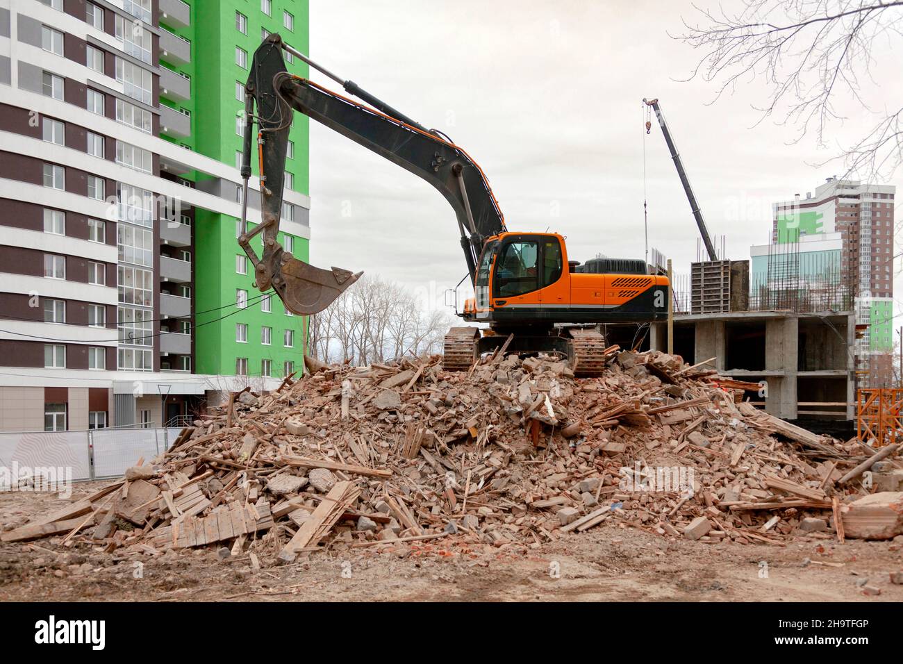 Demolition of an old building by modern excavator Stock Photo - Alamy