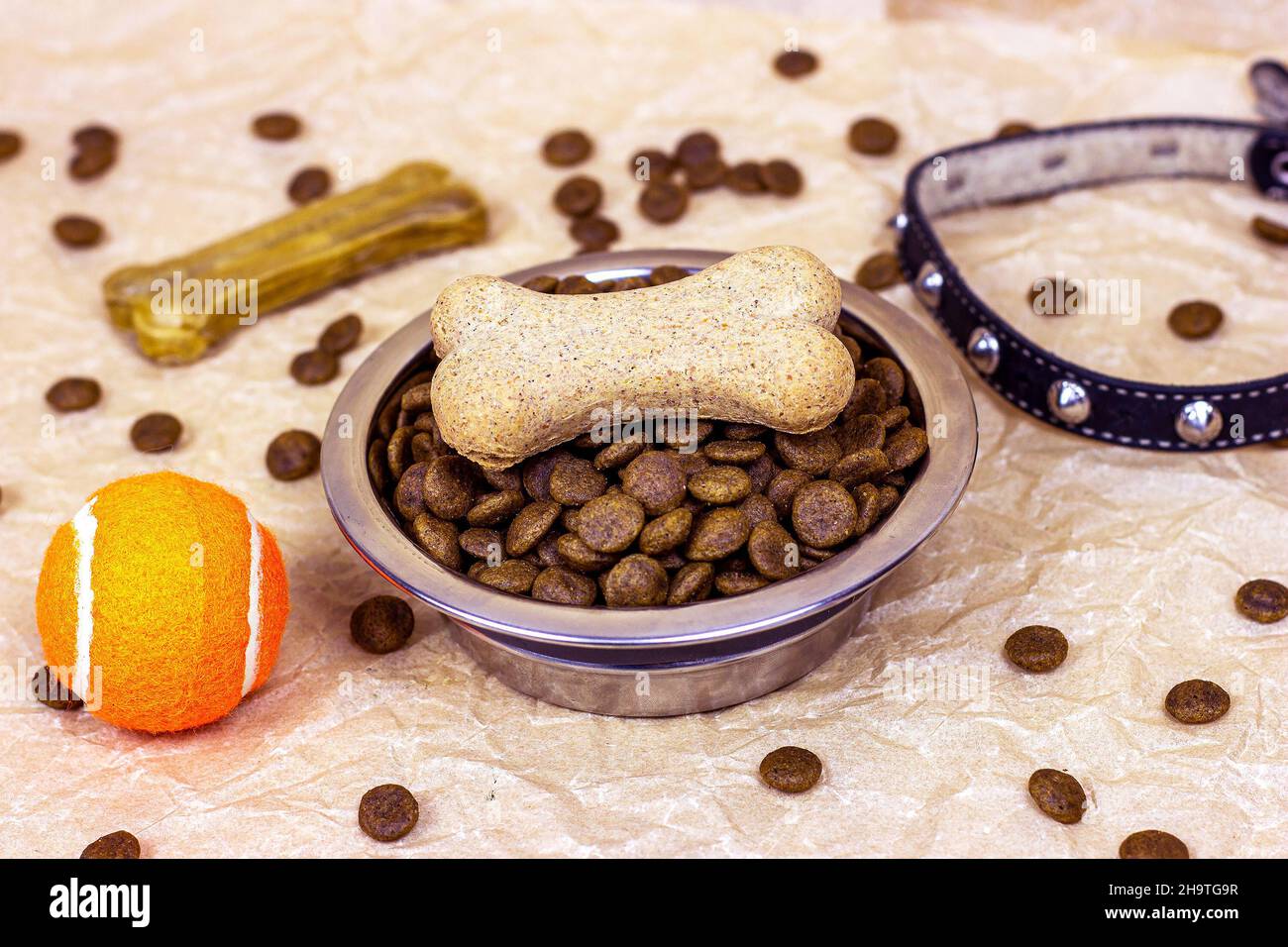 Brown biscuit bones and crunchy organic kibble pieces for dog feed with ...