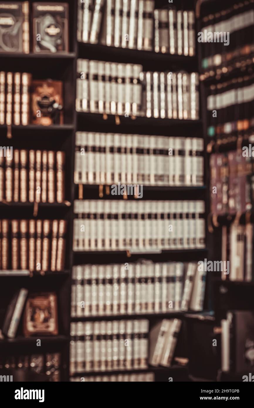 Blurred bookshelves of corner bookcase with books in public library ...