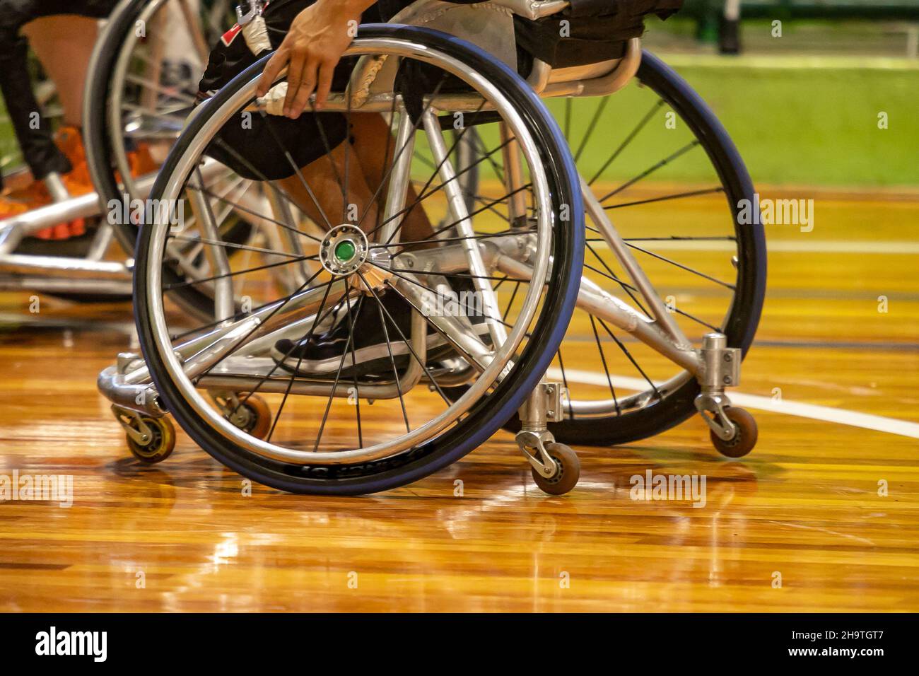 Basketball game on wheels with emphasis on the wheel of a chair, at the ...
