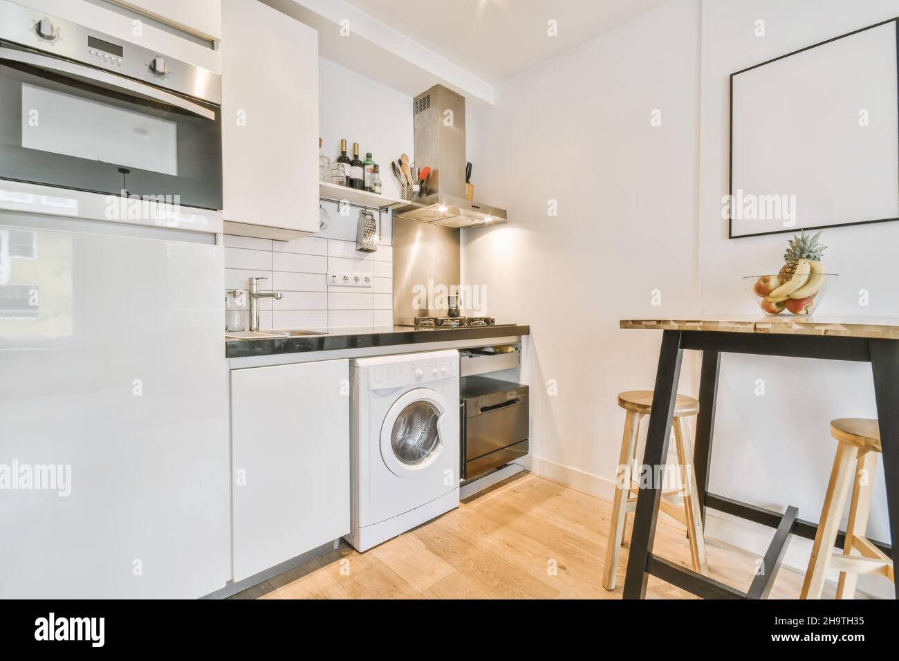 Cozy mini kitchen island in white tones Stock Photo - Alamy
