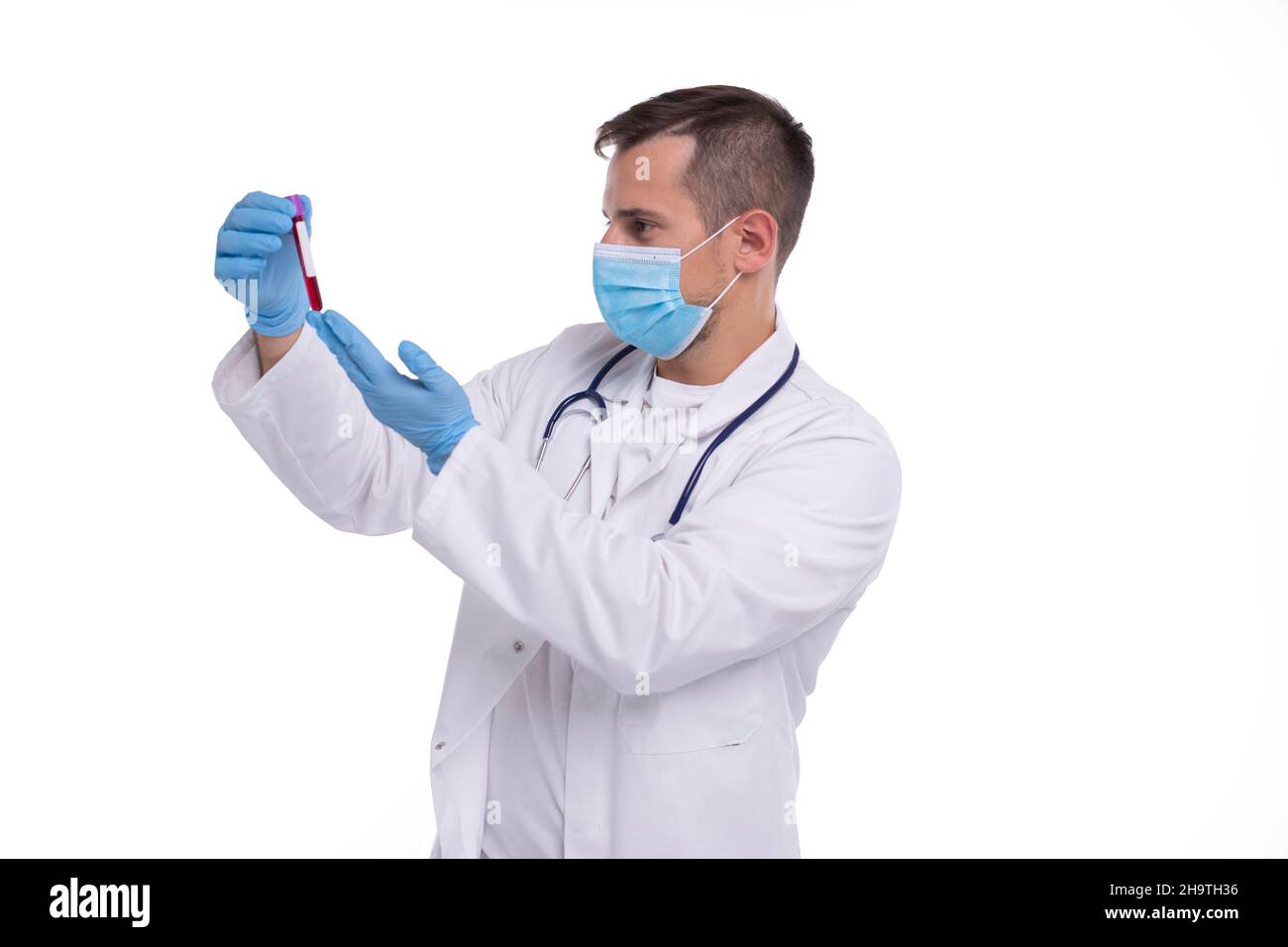 Male Doctor Checking Blood Analysis Wearing Medical Mask and Gloves ...