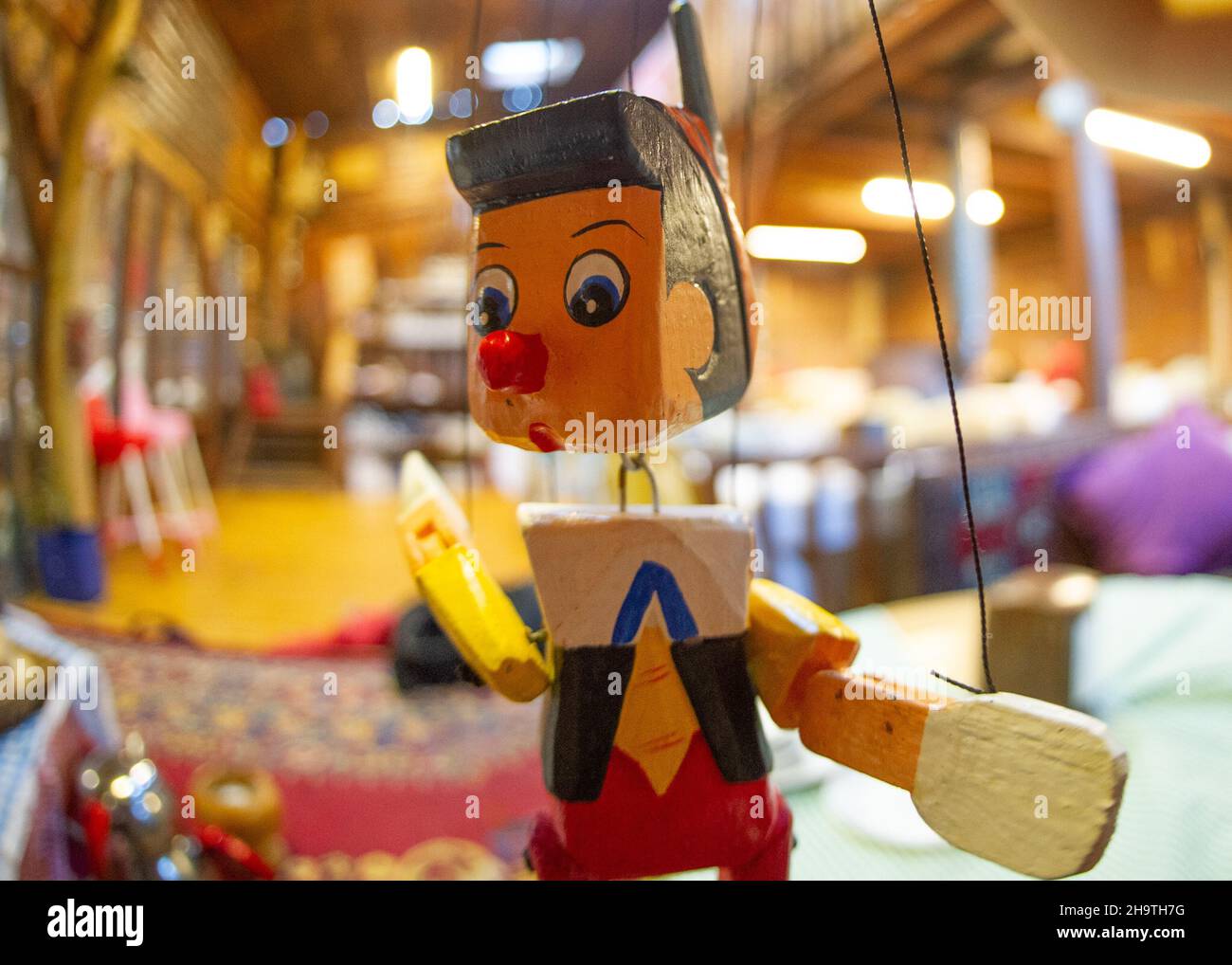 Wooden Pinocchio doll handmade with strings Stock Photo - Alamy