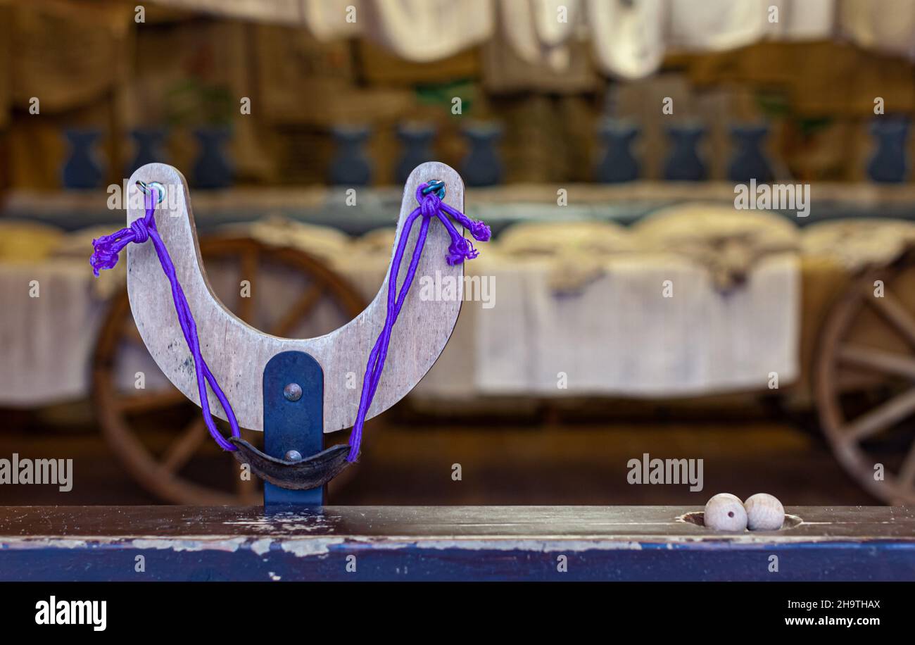 wooden slingshot in the shooting range on the background of targets ...