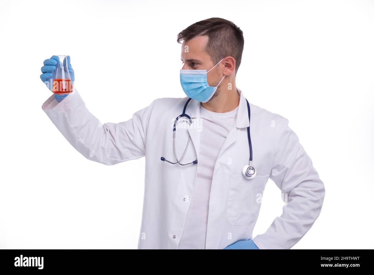 Man Doctor Examing Flask with Colorfull Liquid Wearing Medical Mask ...