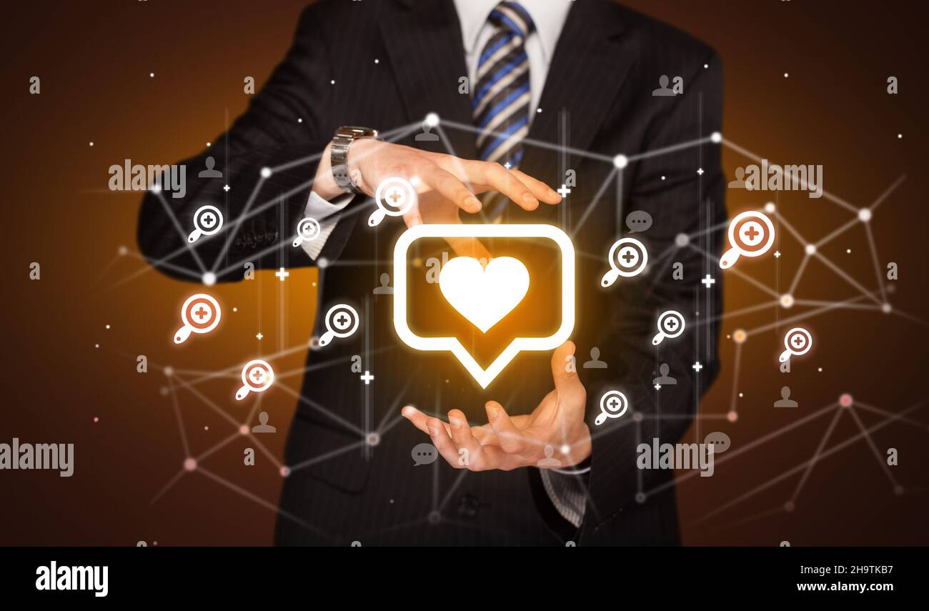 Hand holding social media icons Stock Photo - Alamy