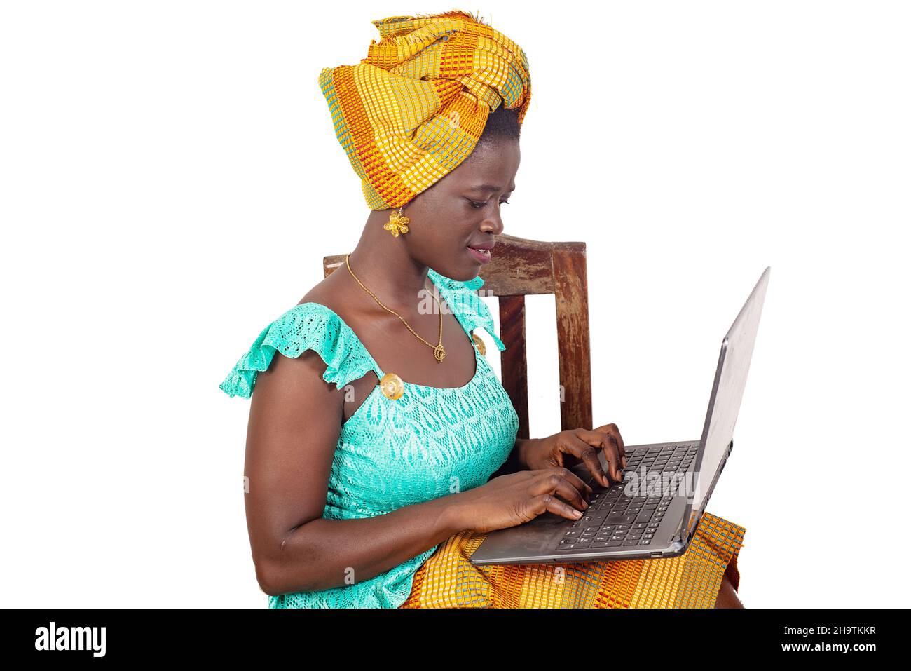 a beautiful African businesswoman in traditional dress sitting on a ...