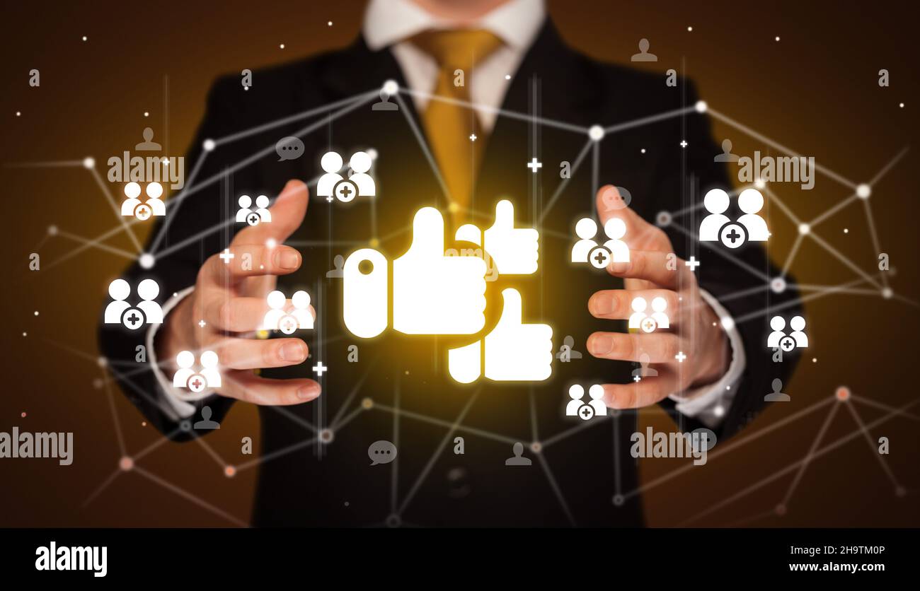 Hand holding social media icons Stock Photo - Alamy