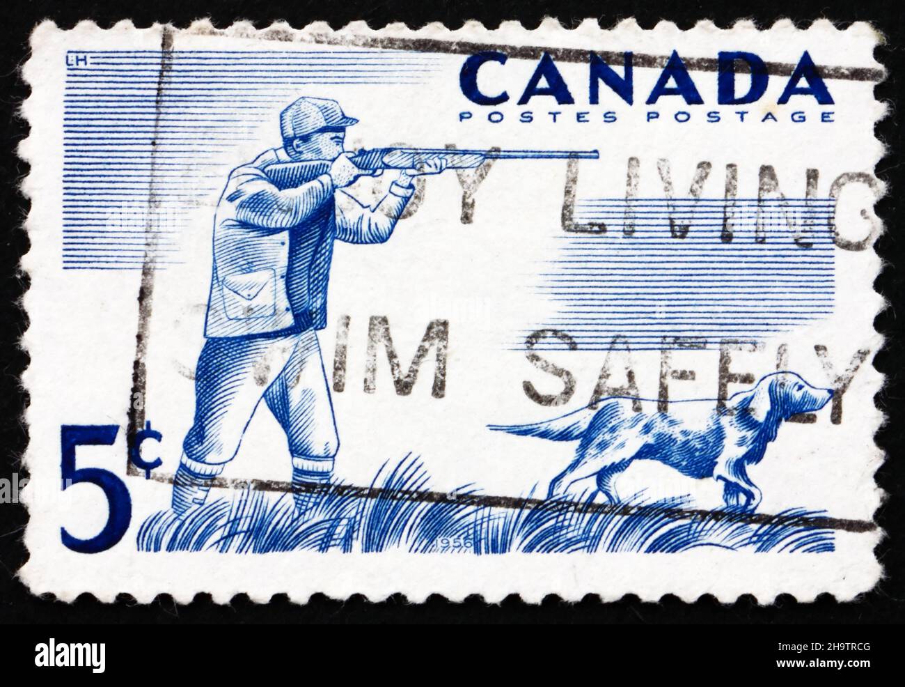 CANADA - CIRCA 1957: a stamp printed in the Canada shows Hunter and Dog ...