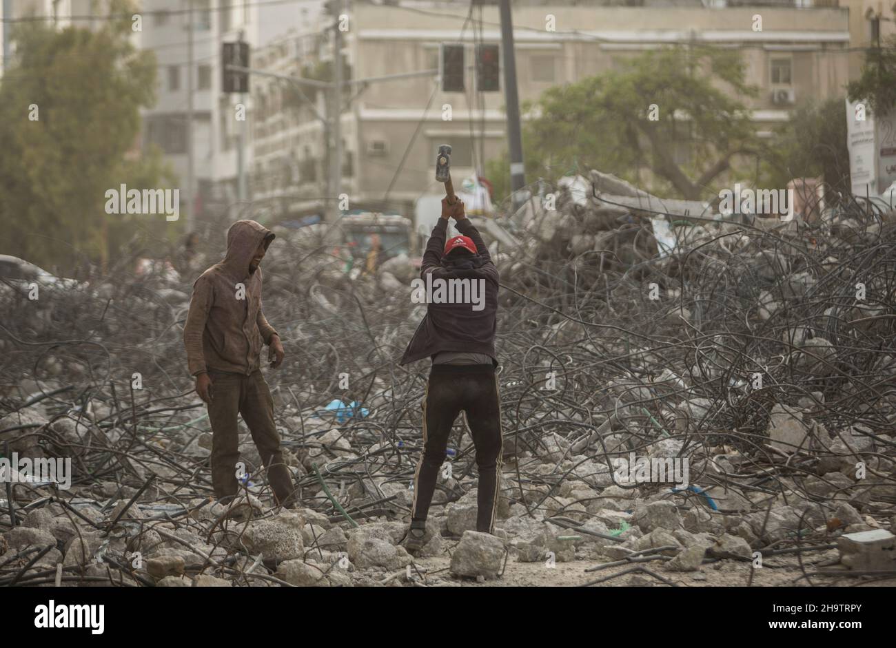 Gaza, Palestine. 08th Dec, 2021. Palestinian workers remove the rubble ...