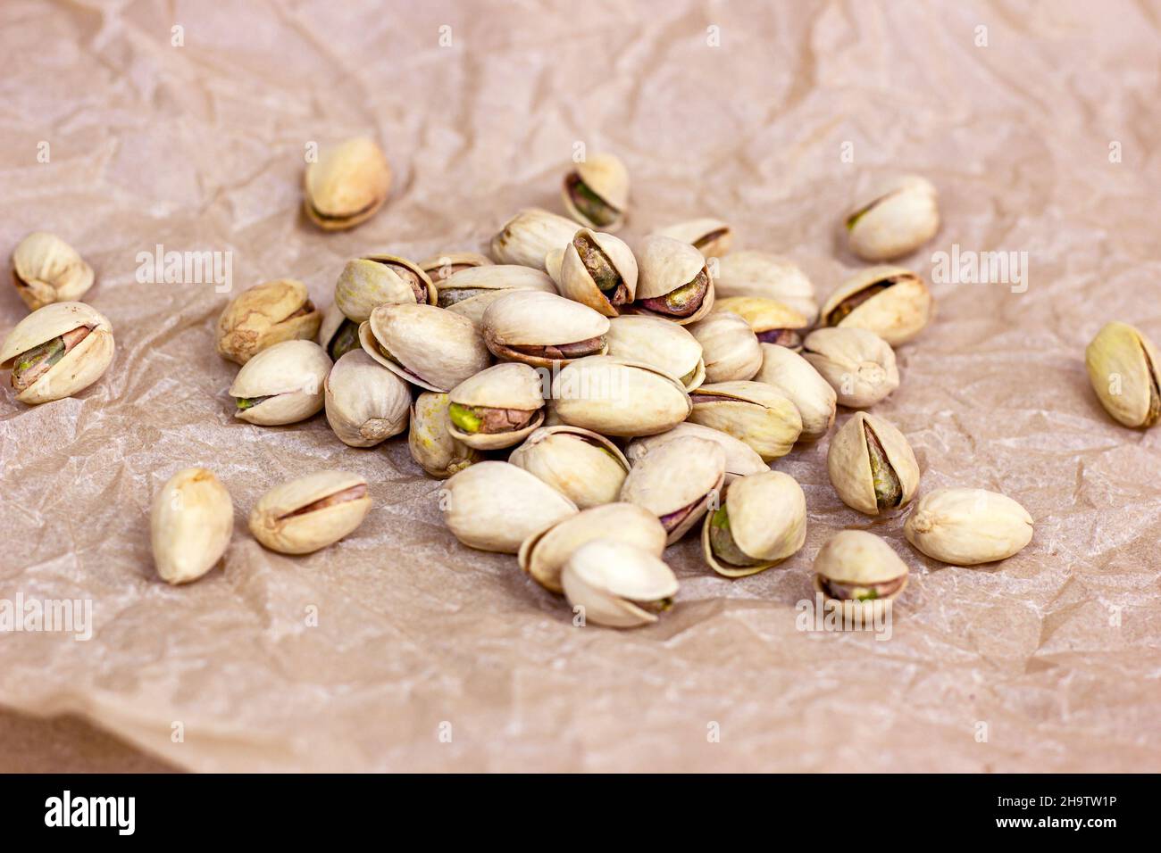 Roasted salted pistachio nuts in nutshell on light background Stock Photo - Alamy
