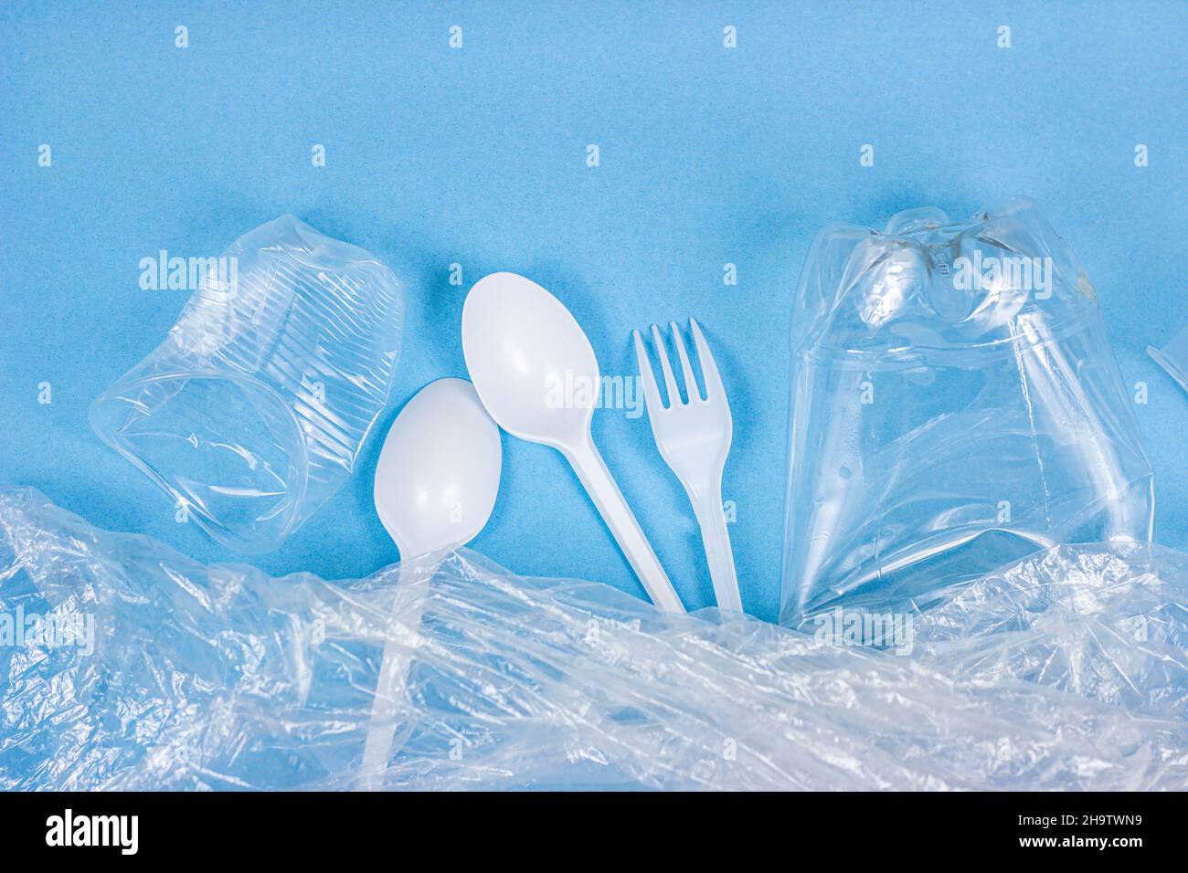 Top view of crushed plastic spoons, forks and cups as a disposable ...