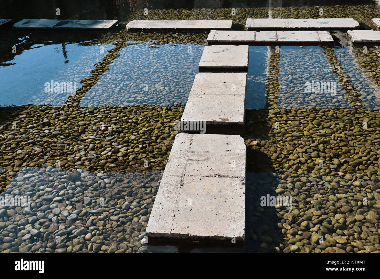 Stone tiles through Water in a Lost Place Stock Photo - Alamy