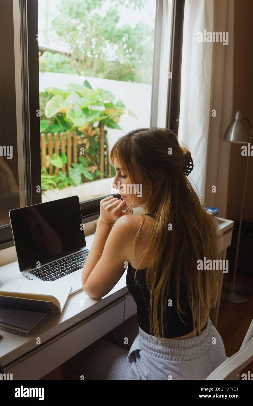Young woman studying in her room Stock Photo - Alamy