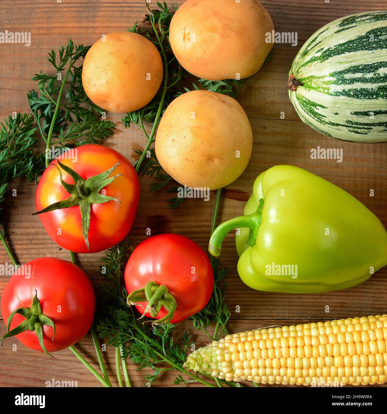 A set of vegetables laid out on a wooden table. Flat lay,top view Stock ...