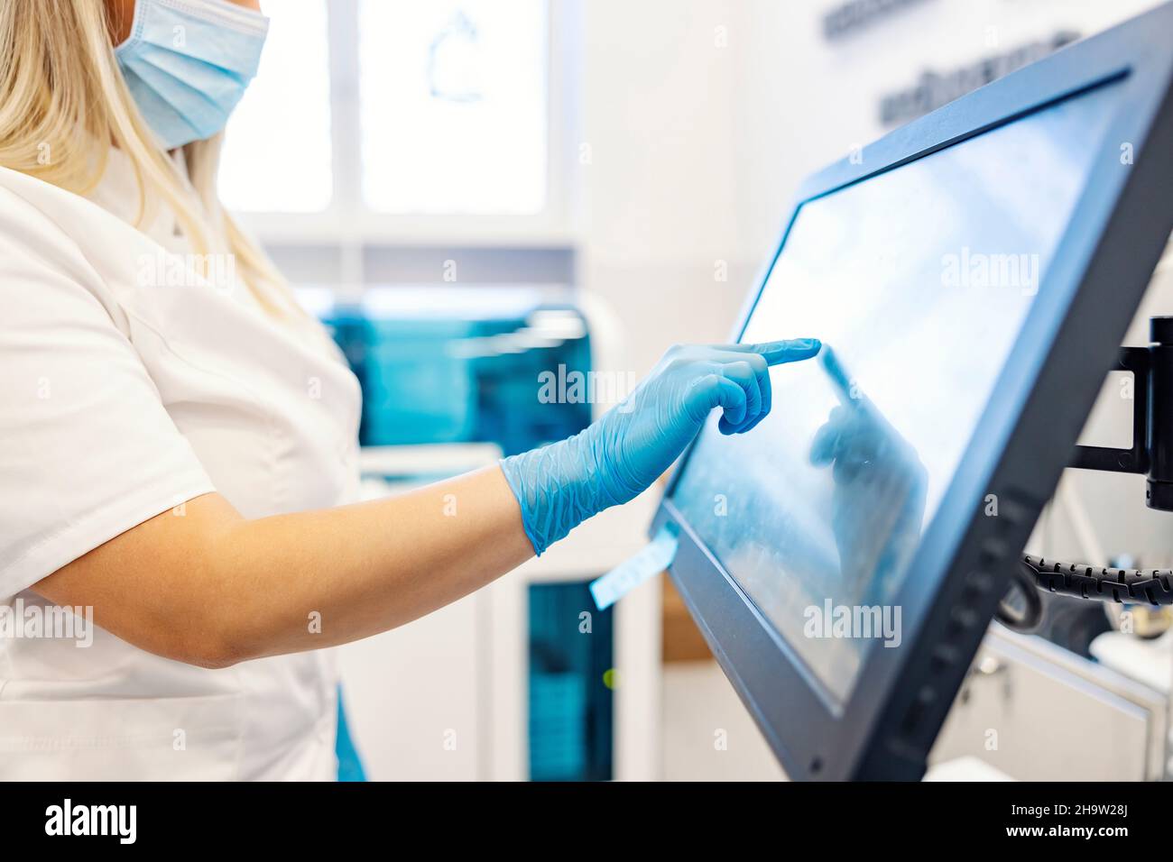 Modern technology in the lab. A nurse is standing next to a machine for ...