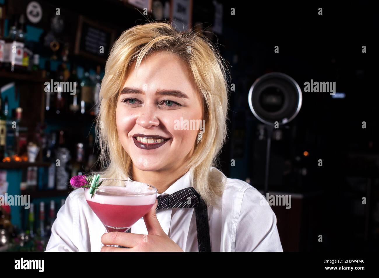 Confident woman bartending is pouring a drink in the bar Stock Photo ...