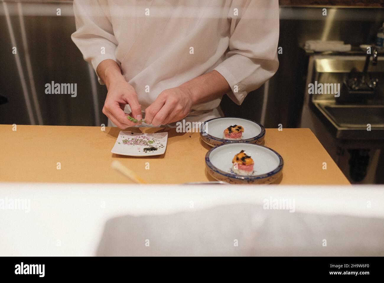 Chef making sashimi in a kitchen of a restaurant Stock Photo - Alamy