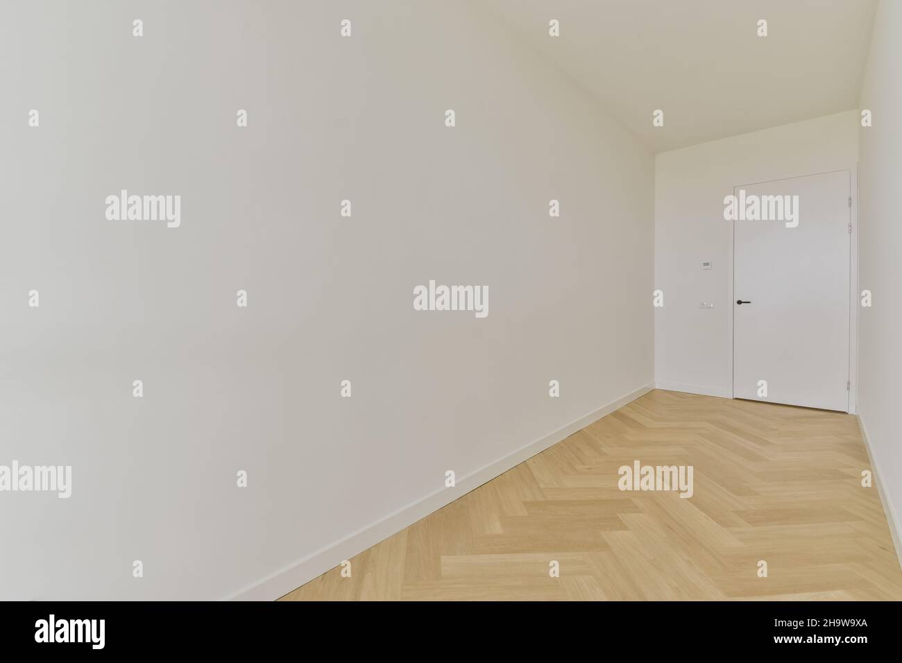 Long narrow empty room with parquet floor Stock Photo - Alamy