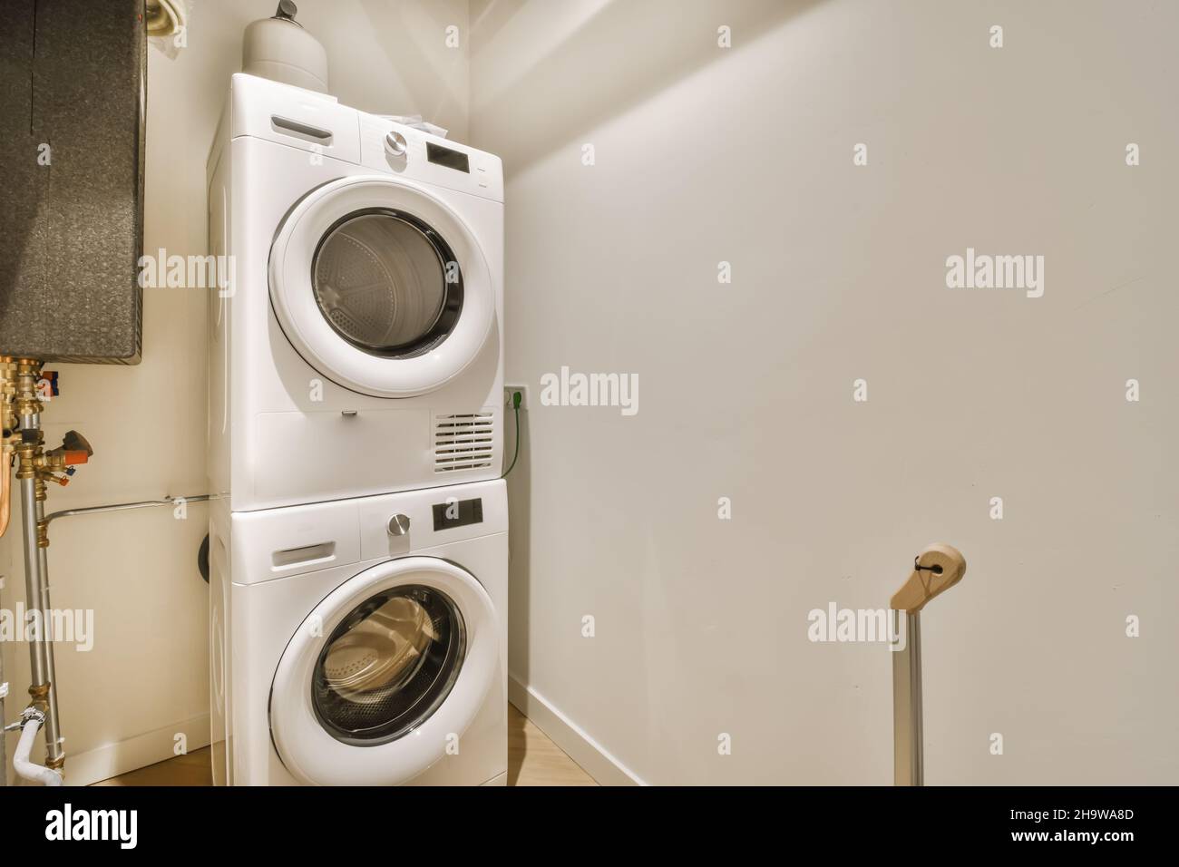 Laundry room with washing machine and tumble dryer Stock Photo - Alamy