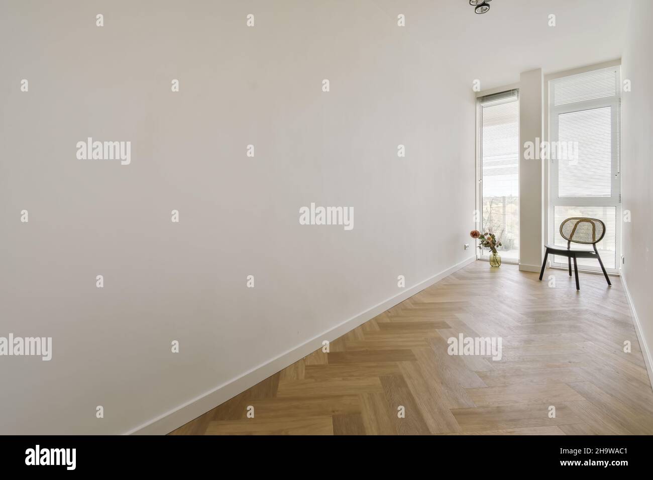 Long narrow empty room with parquet floor Stock Photo - Alamy
