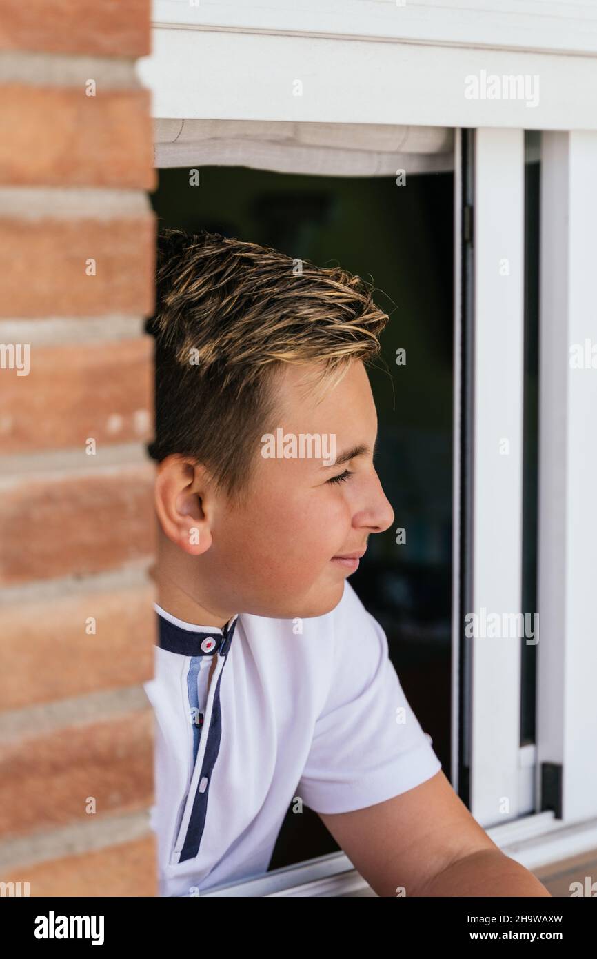 Cool teen boy looking out window Stock Photo - Alamy