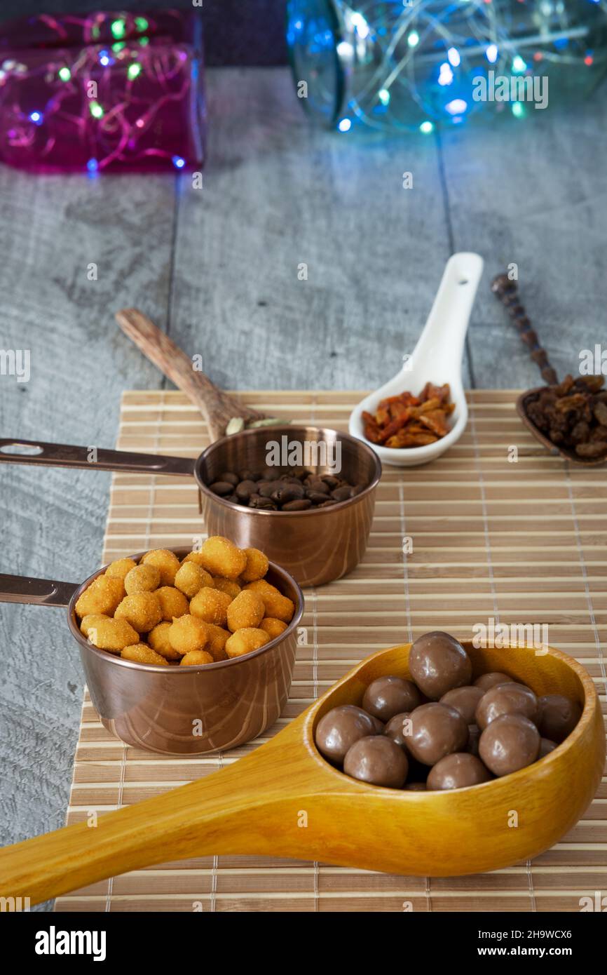 Still life with chocolates, nuts and decorative colored lights Stock ...
