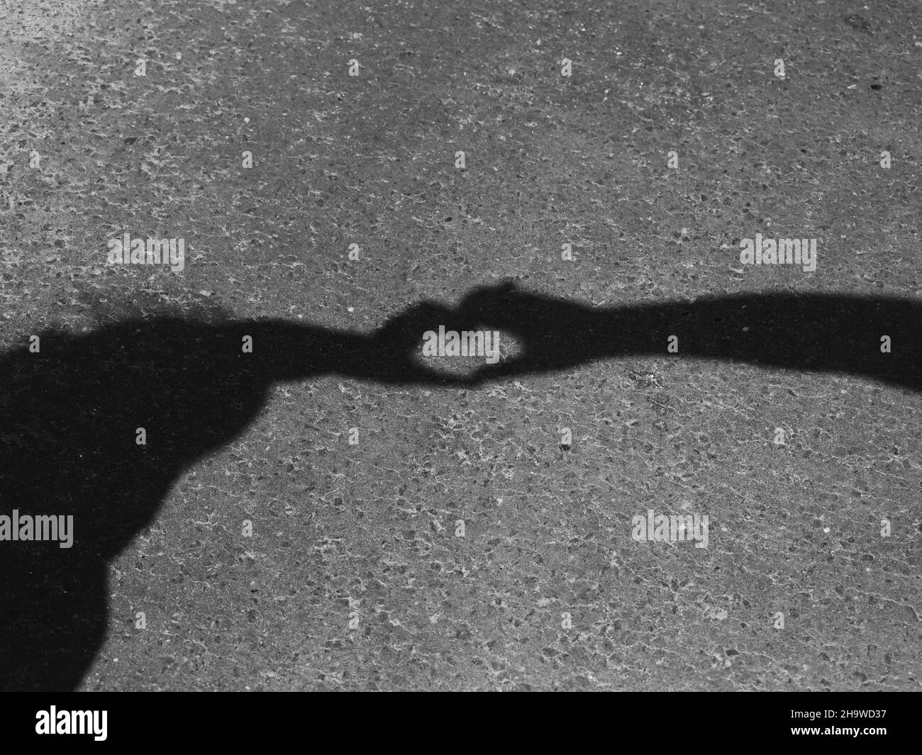 Shadow two hands forming heart hi-res stock photography and images - Alamy