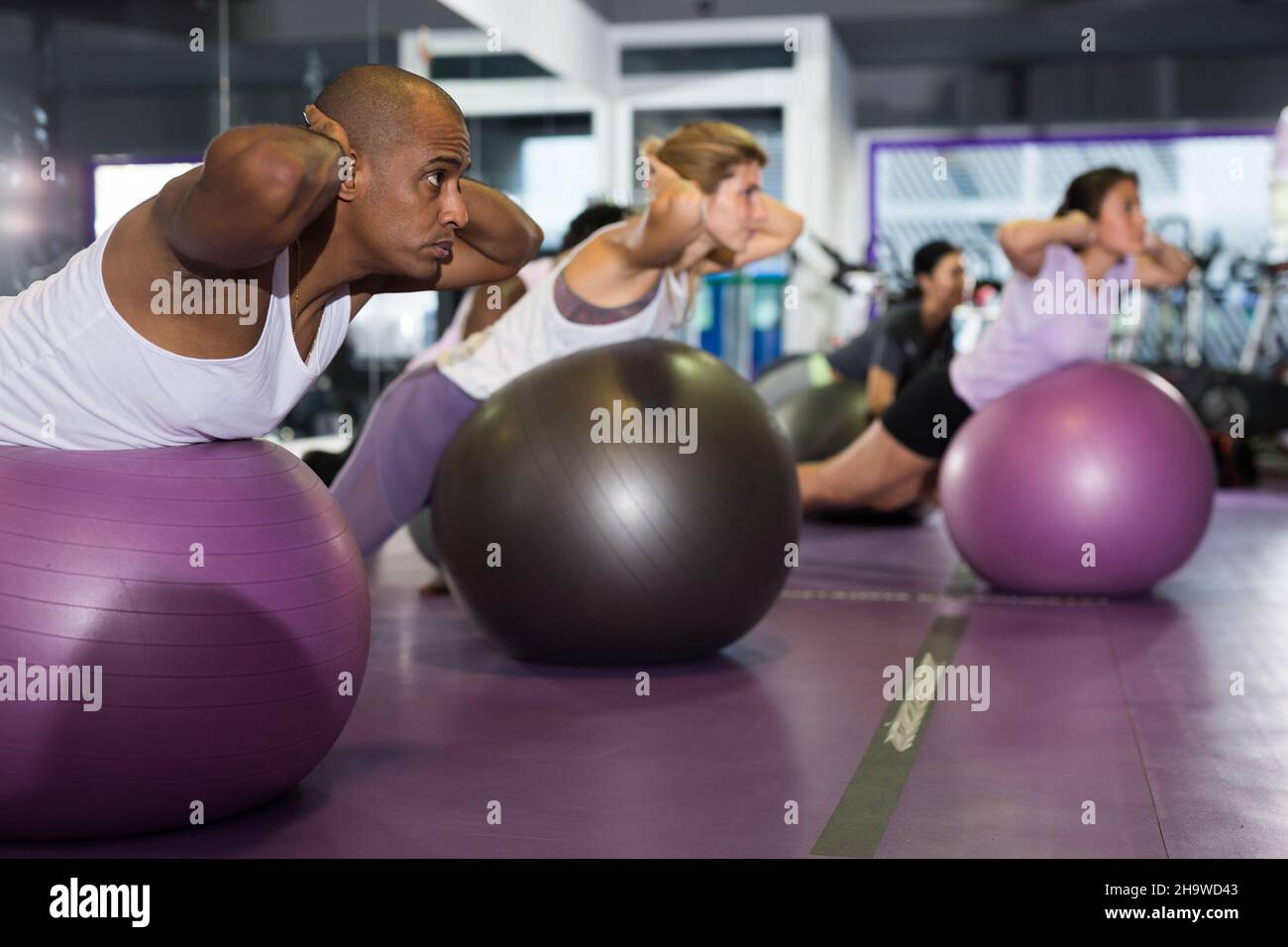 People working out with aerobic ball in modern gym Stock Photo - Alamy