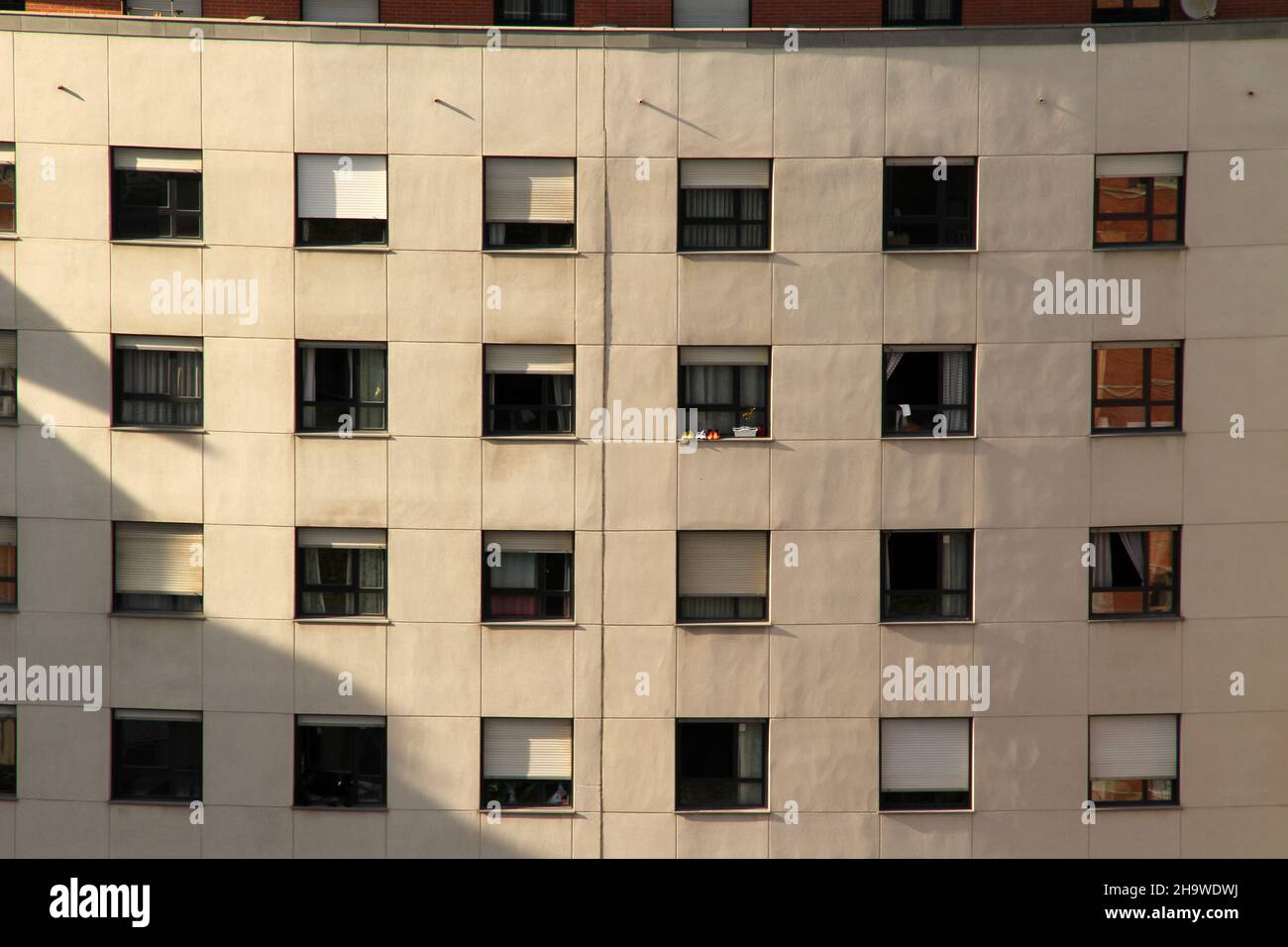 Residential building facade with rows of square windows in Bilbao ...